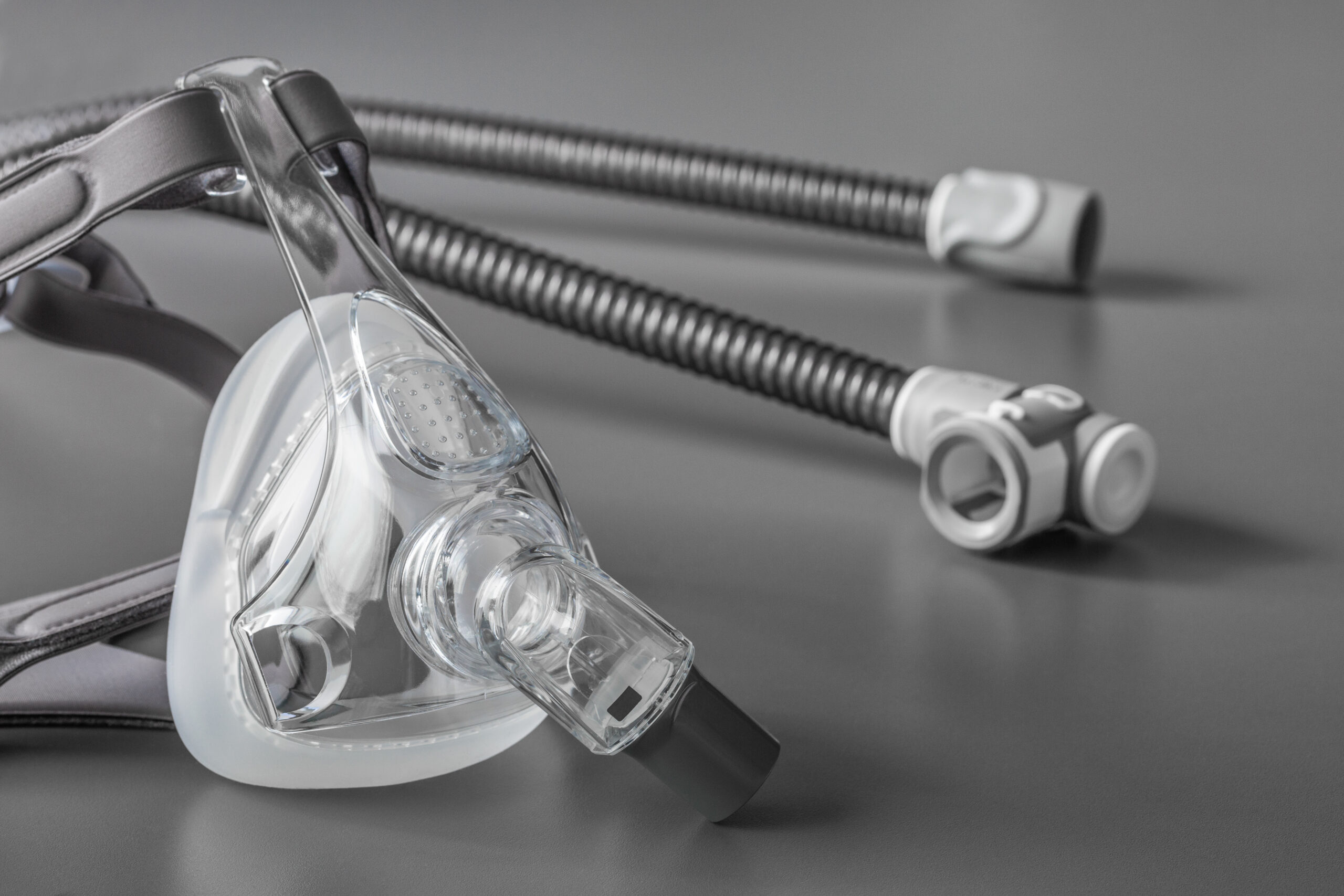 Sleep apnea CPAP mask on the grey background – Sleep Medicine DFW